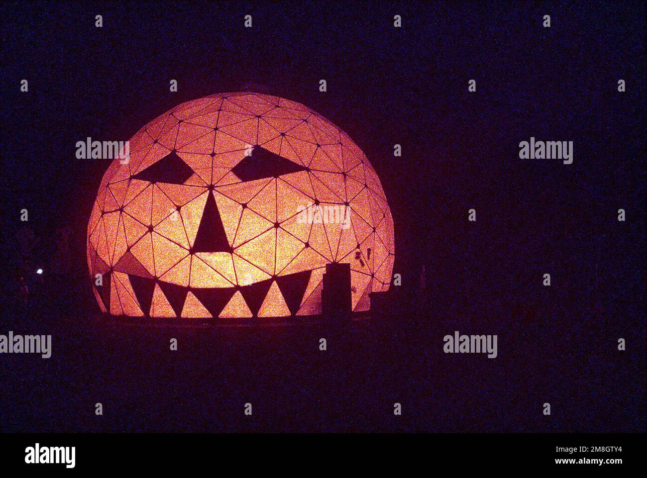 A satellite communications dome is lighted and decorated to represent ...