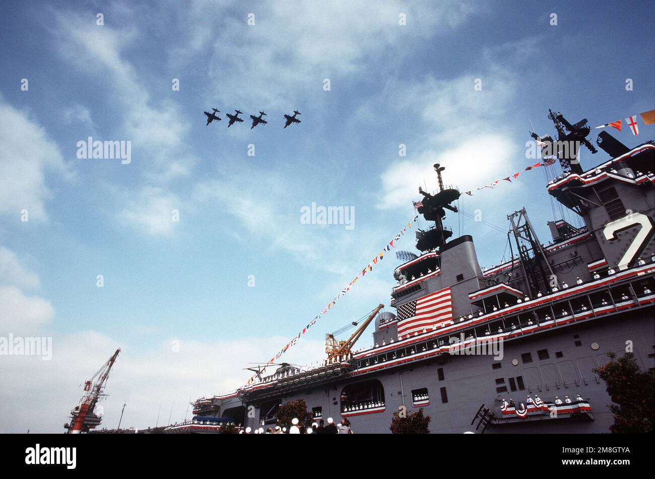 Crew members man the rails aboard the amphibious assault ship USS ESSEX ...