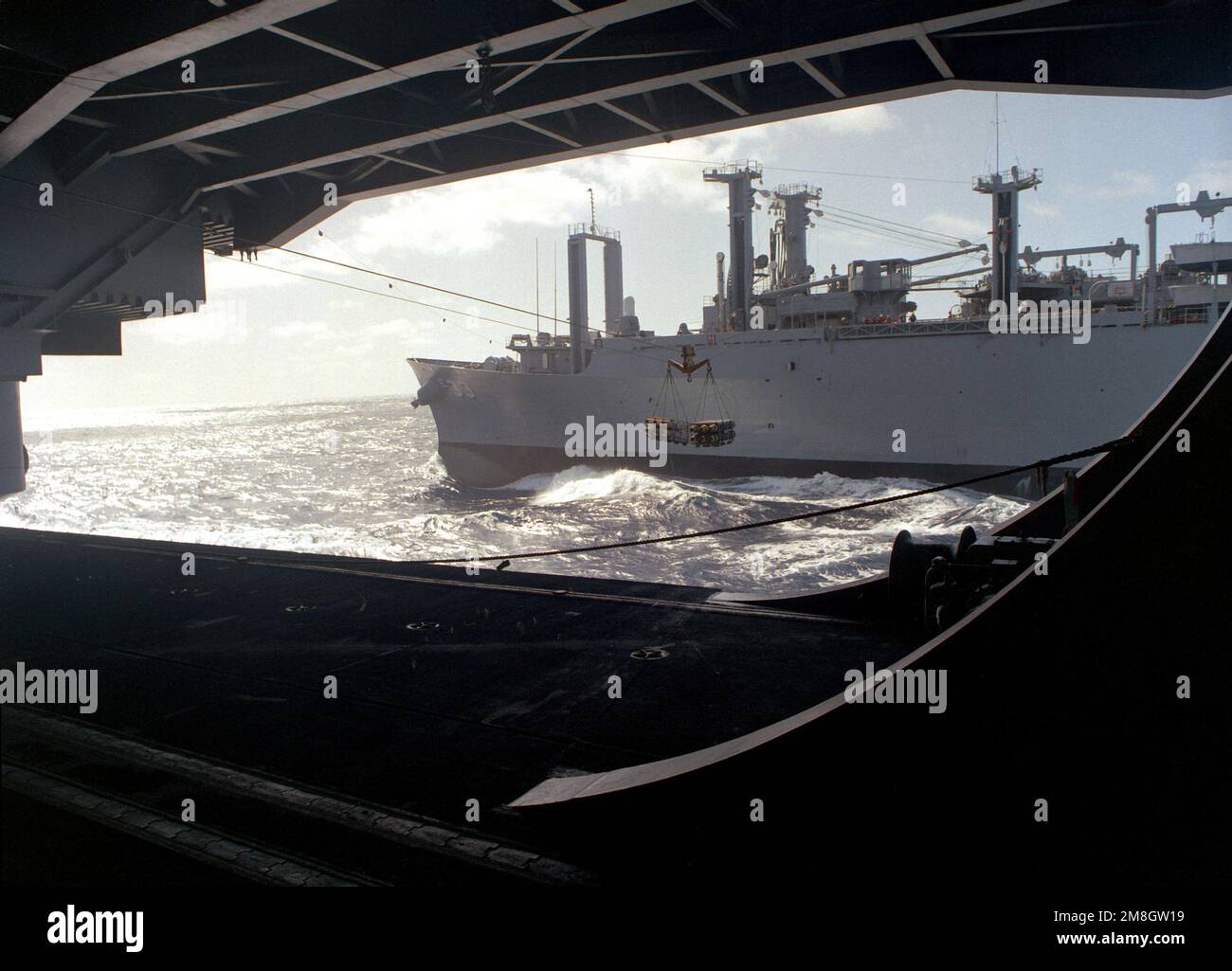 Ordnance is highlined from the ammunition ship USS SHASTA (AE-33) to ...