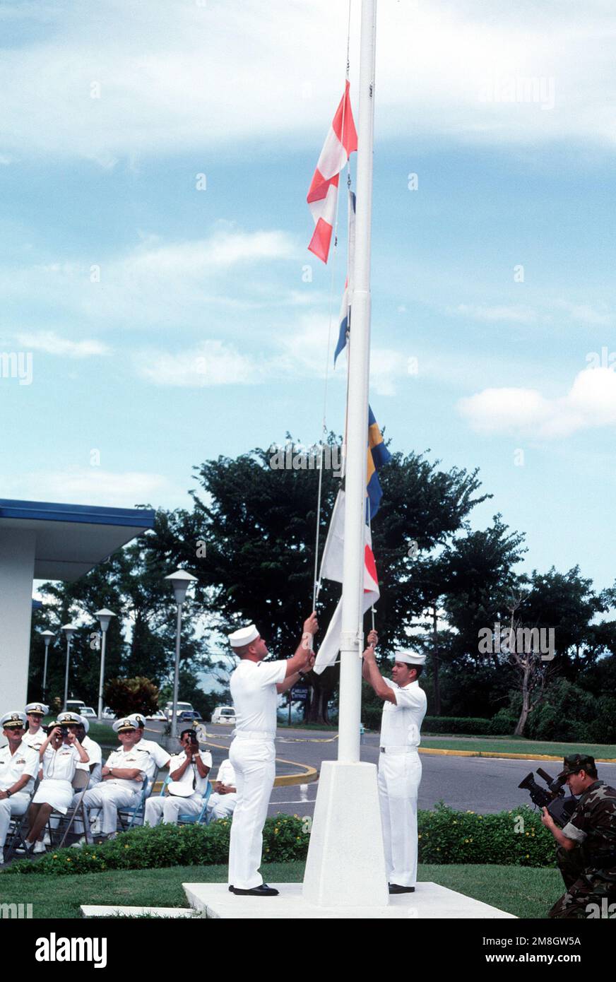 Hospital corpsmen lower pennants during the closing ceremony for Naval ...