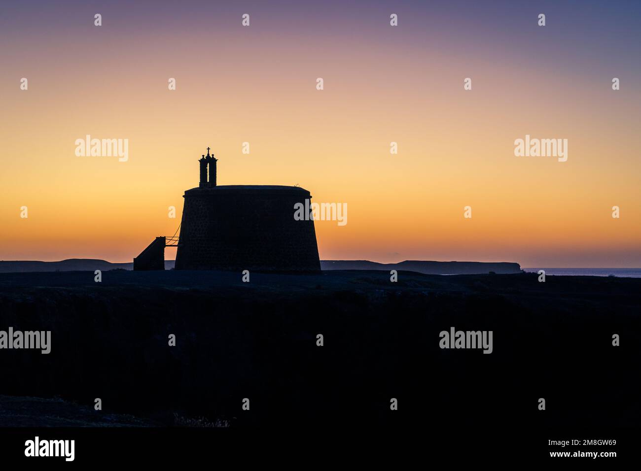 The Castillo de San Marcial is nicely silhouetted by the sunrise. Playa ...