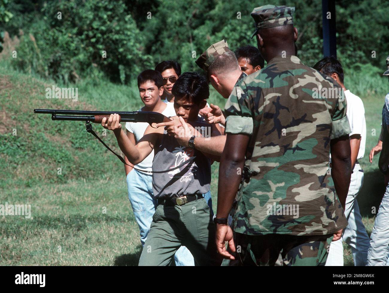 A member of the Subic Bay Metropolitan Authority (SBMA) aims a 12 gauge ...