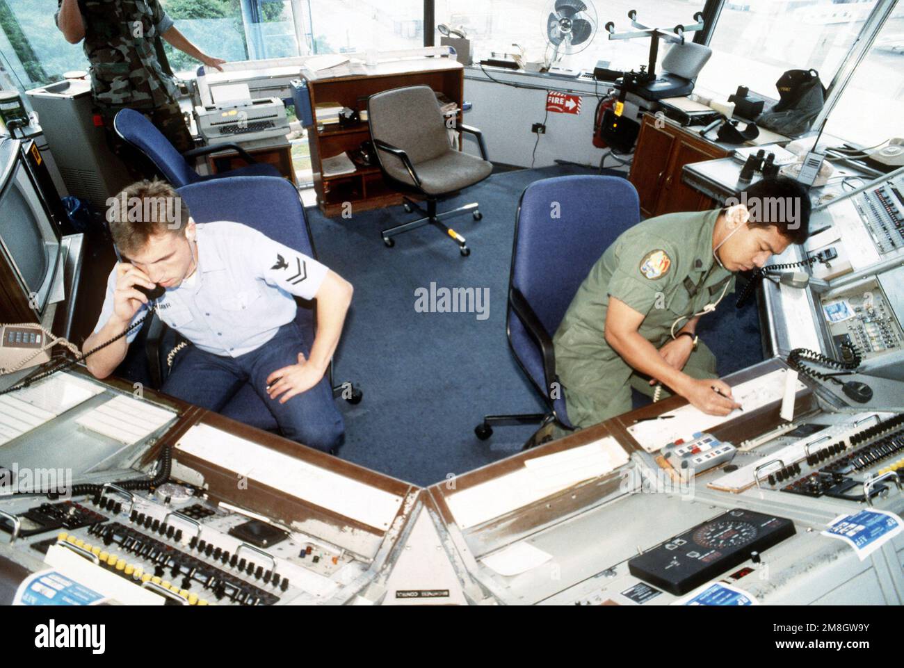 Air controlman 2nd Class John Mahr instructs SSGT Roque Exconde on U.S ...