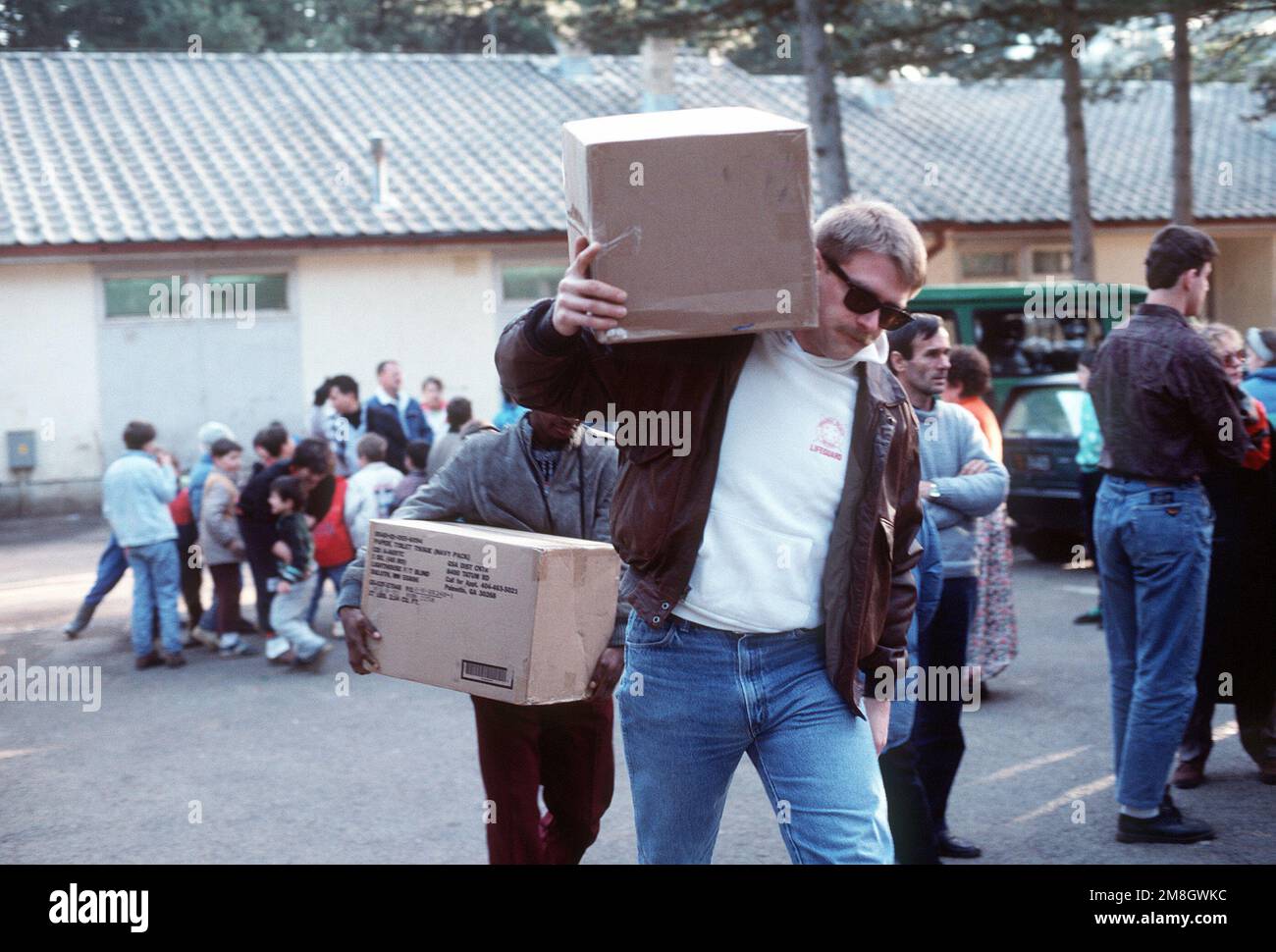Crew members from the amphibious assault ship USS GUAM (LPH-9) carry ...