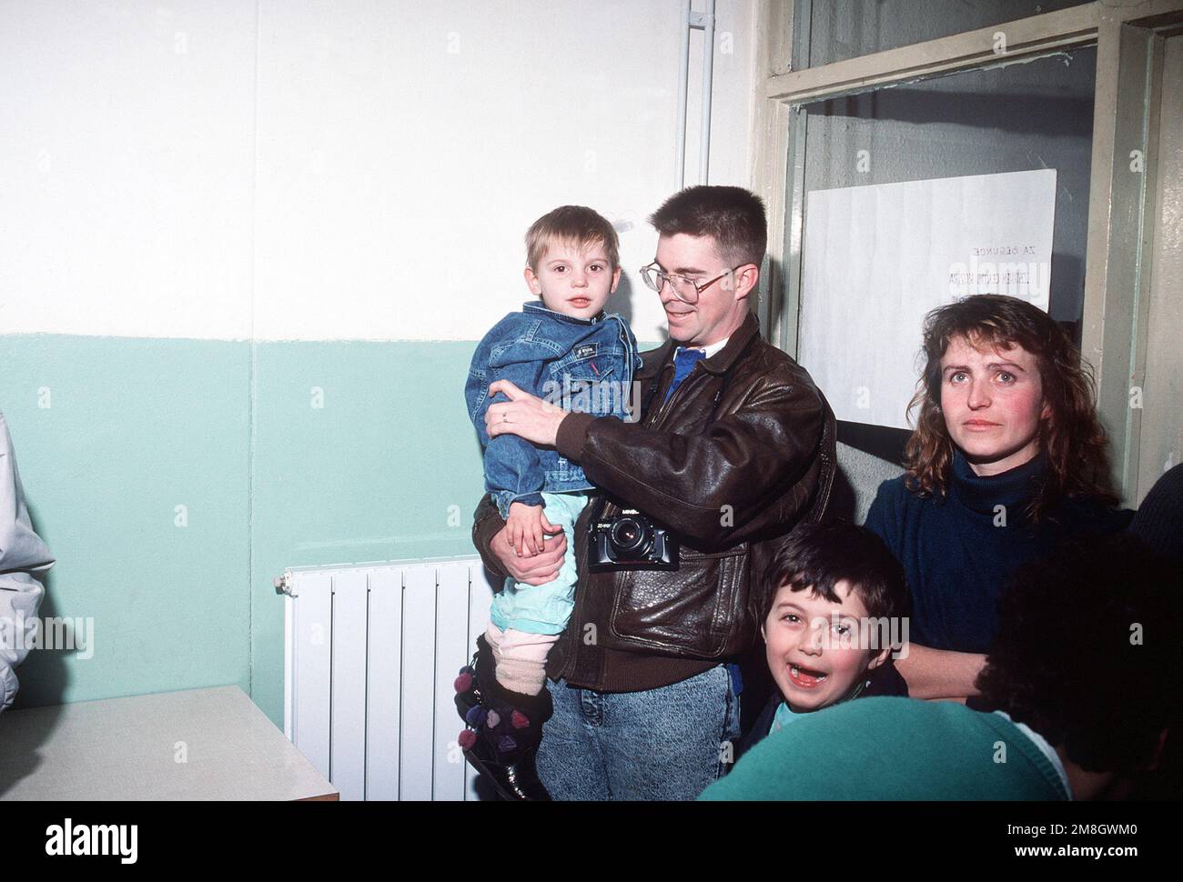 A crew member from the amphibious assault ship USS GUAM (LPH-9) holds a ...