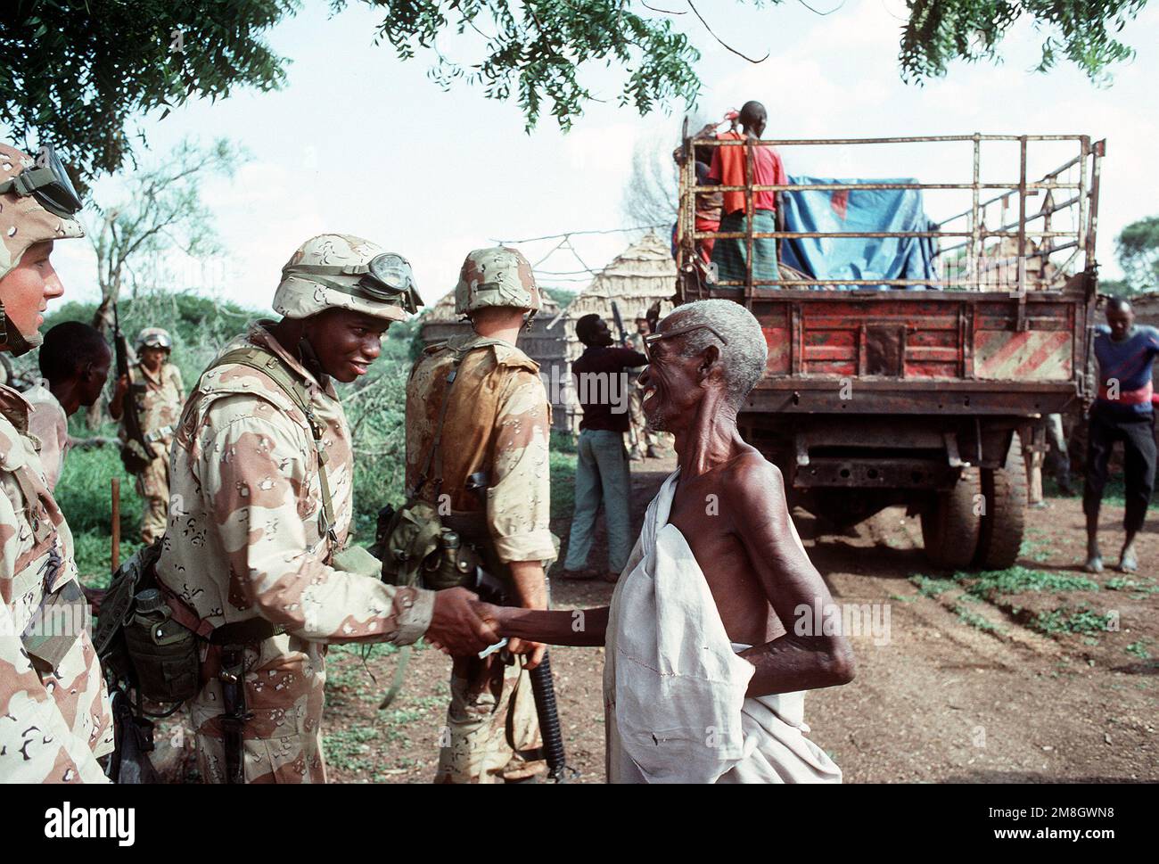 A village elder welcomes Marine SGT. Mark Holloway as he and other ...
