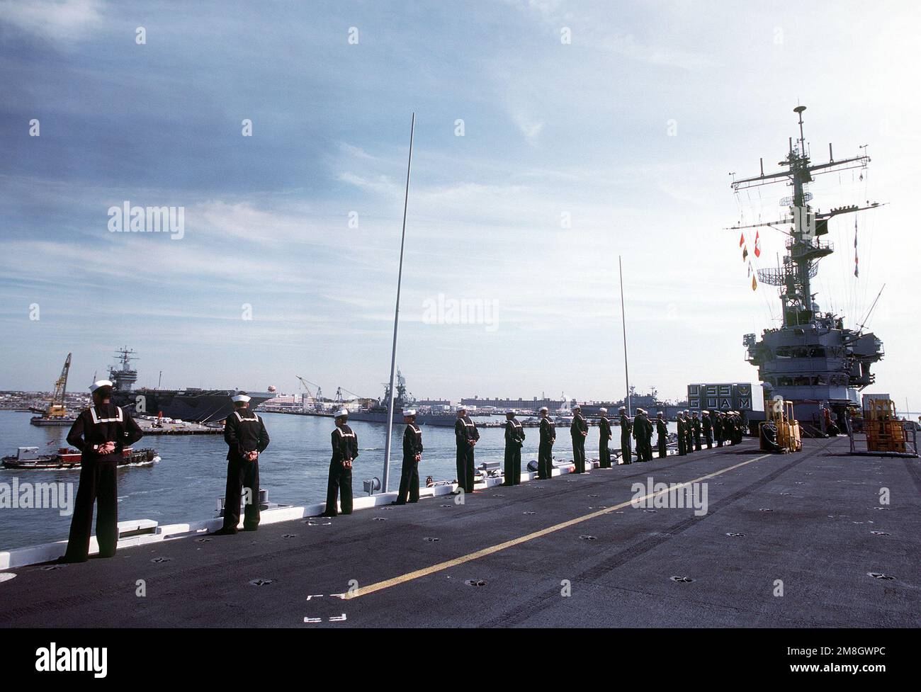 Sailors man the rails aboard the amphibious assault ship USS GUAM (LPH ...