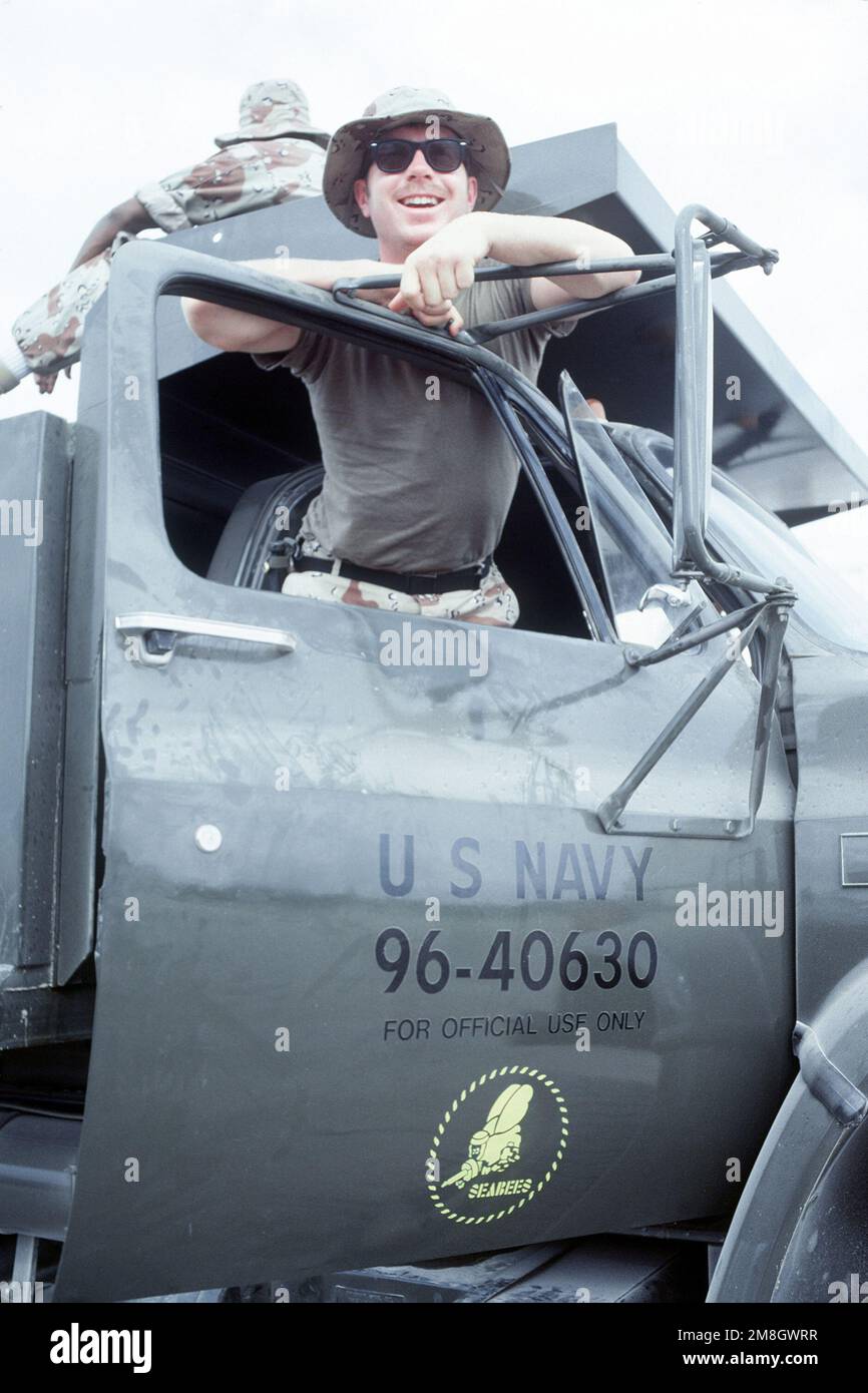 A member of Naval Mobile Construction Battalion 40 (NMCB-40) smiles for ...