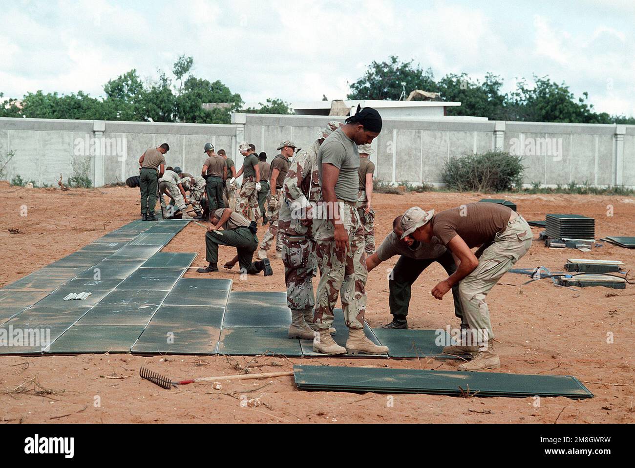 Marines and Seabees work together to build a helicopter landing pad at ...
