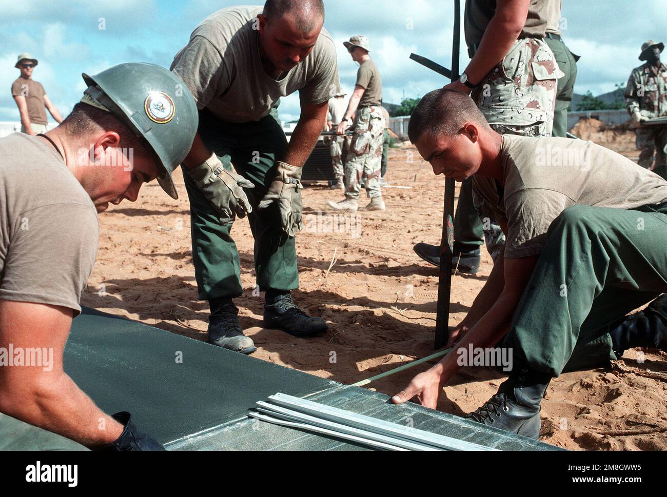 Seabees and Marines work together to build a helicopter landing at the ...