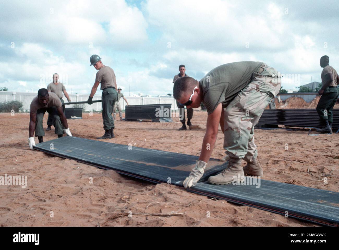 Marines and Seabees work together to build a helicopter landing pad at ...