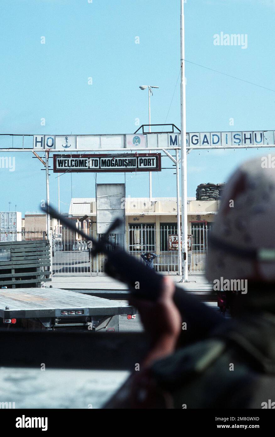 U.S. vehicles drive past the welcome sign at the entrace to the port ...
