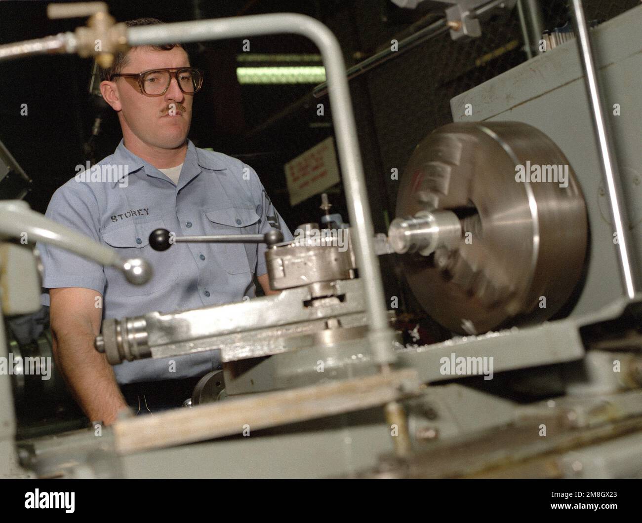 Aviation Structural Mechanic 2nd Class Storey uses a lathe to turn a ...