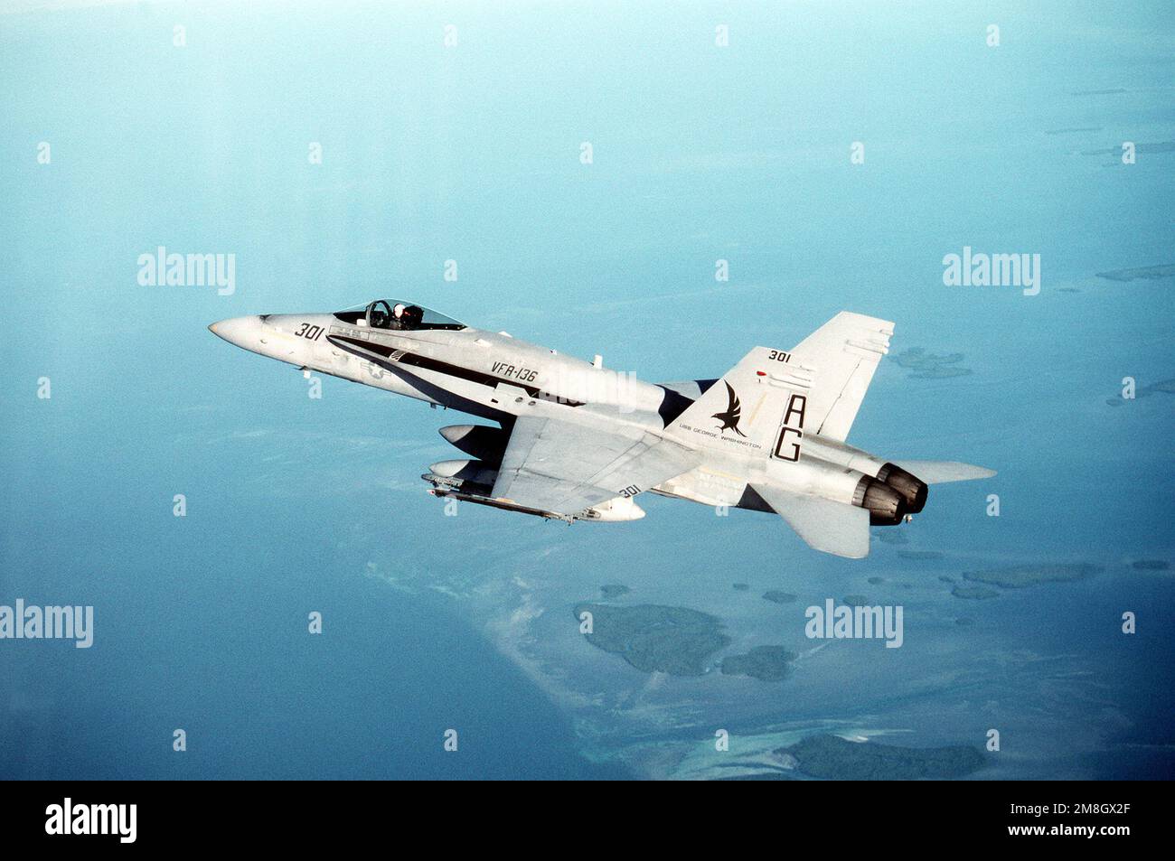 An air-to-air left side view of a Strike Fighter Squadron 136 (VFA-136 ...