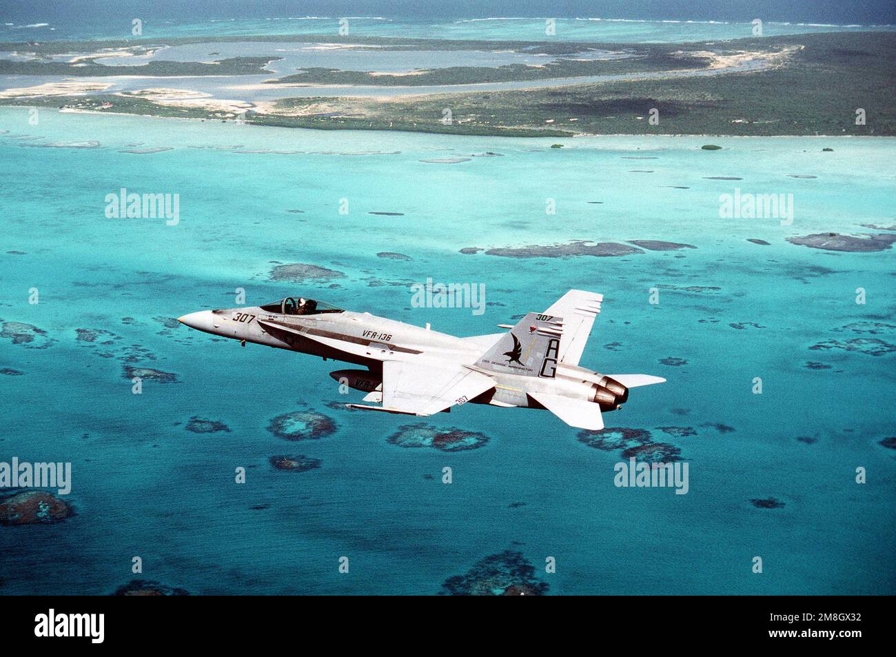 An air-to-air left side view of a Strike Fighter Squadron 136 (VFA-136 ...
