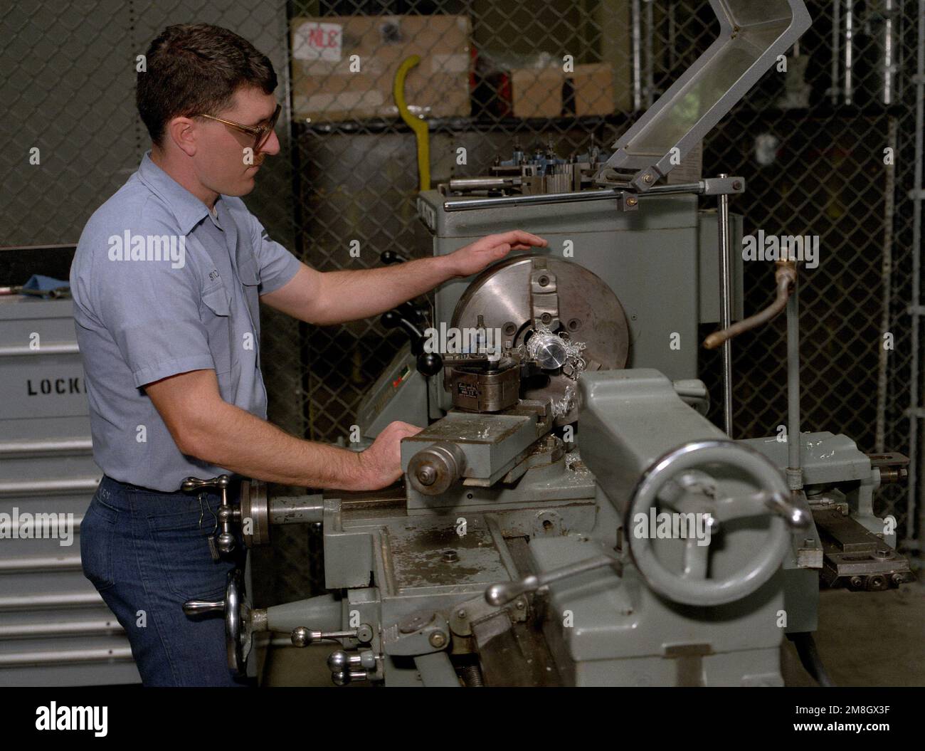 Aviation Structural Mechanic 2nd Class Storey uses a lathe to turn a ...
