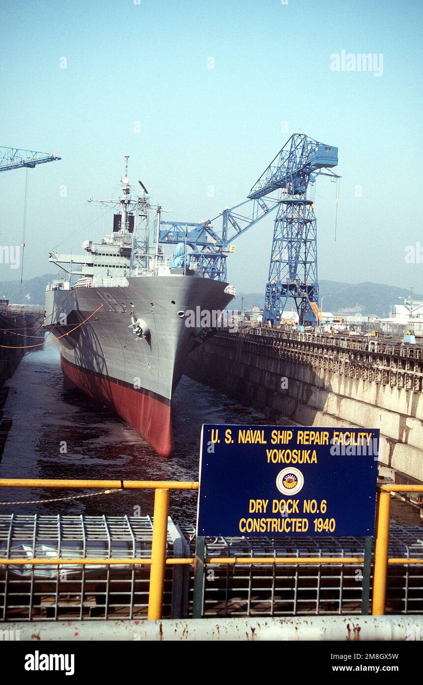Water floods dry dock No. 6 holding the amphibious command ship USS ...