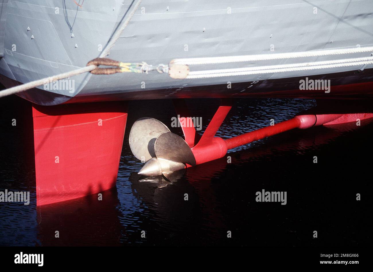 A close-up view of the propeller and rudder of the amphibious command ...