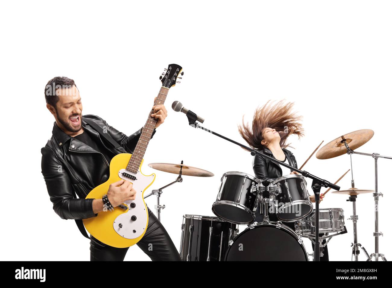 Rock band performing with a female drummer and a male guitairst ...