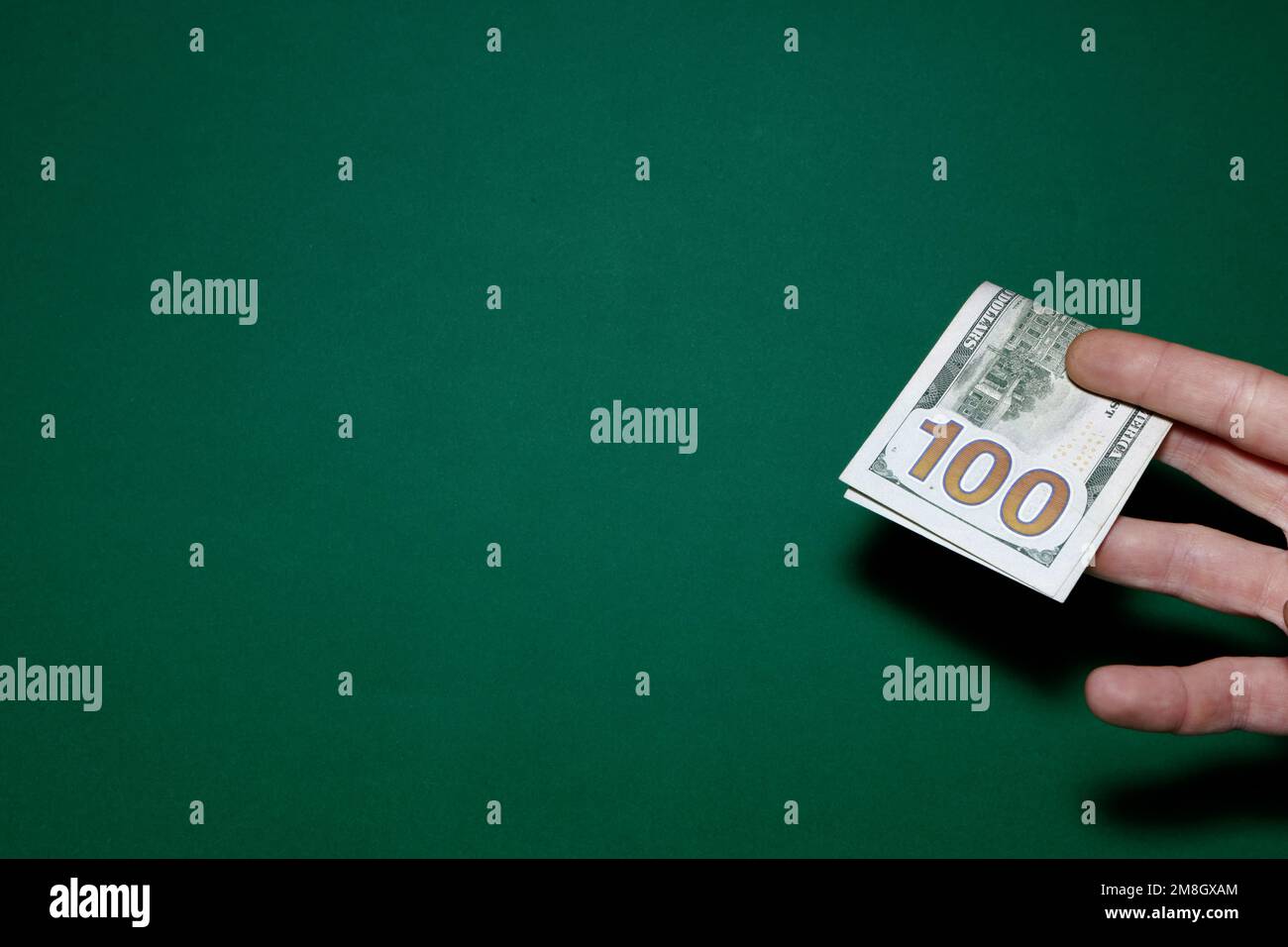 100 dollar bill holds in hand on green background 100 dollar bill ...