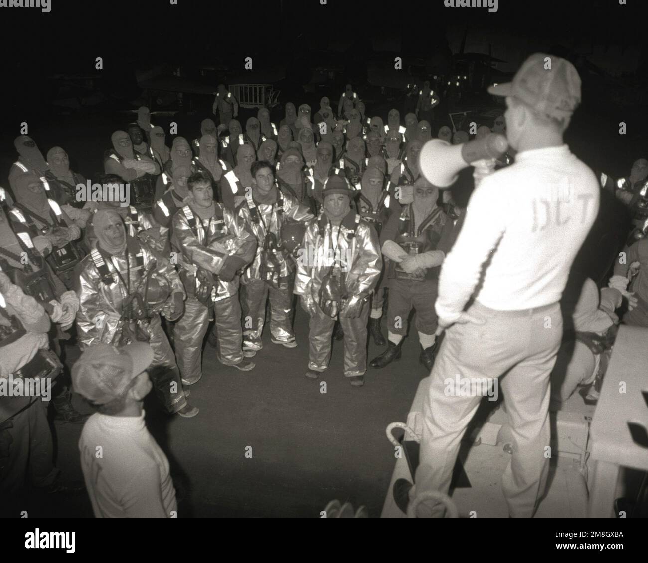 Firefighters wearing proximity suits assemble along with other crew ...