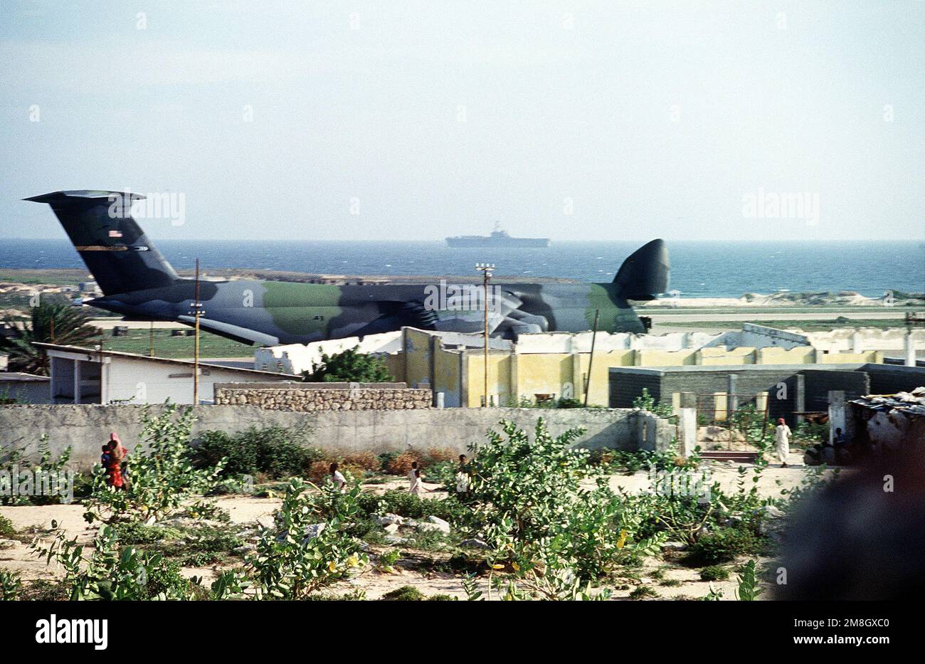 An Air Force C-5 Galaxy aircraft sits on a taxiway during the ...