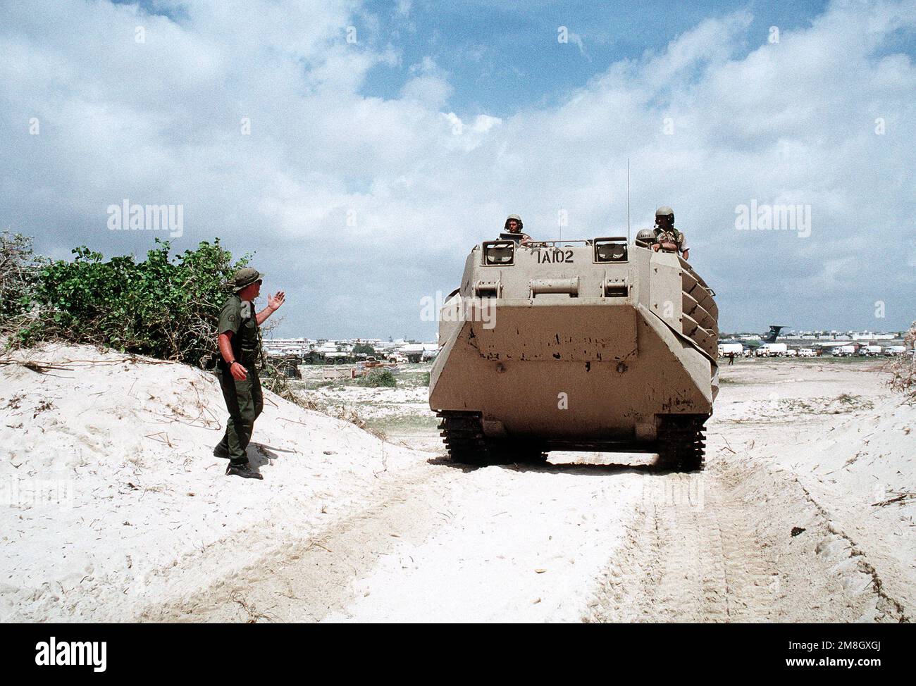 Beachmaster CHIEF Boatswain's Mate Mark Stewart directs a Marine AAV7 ...