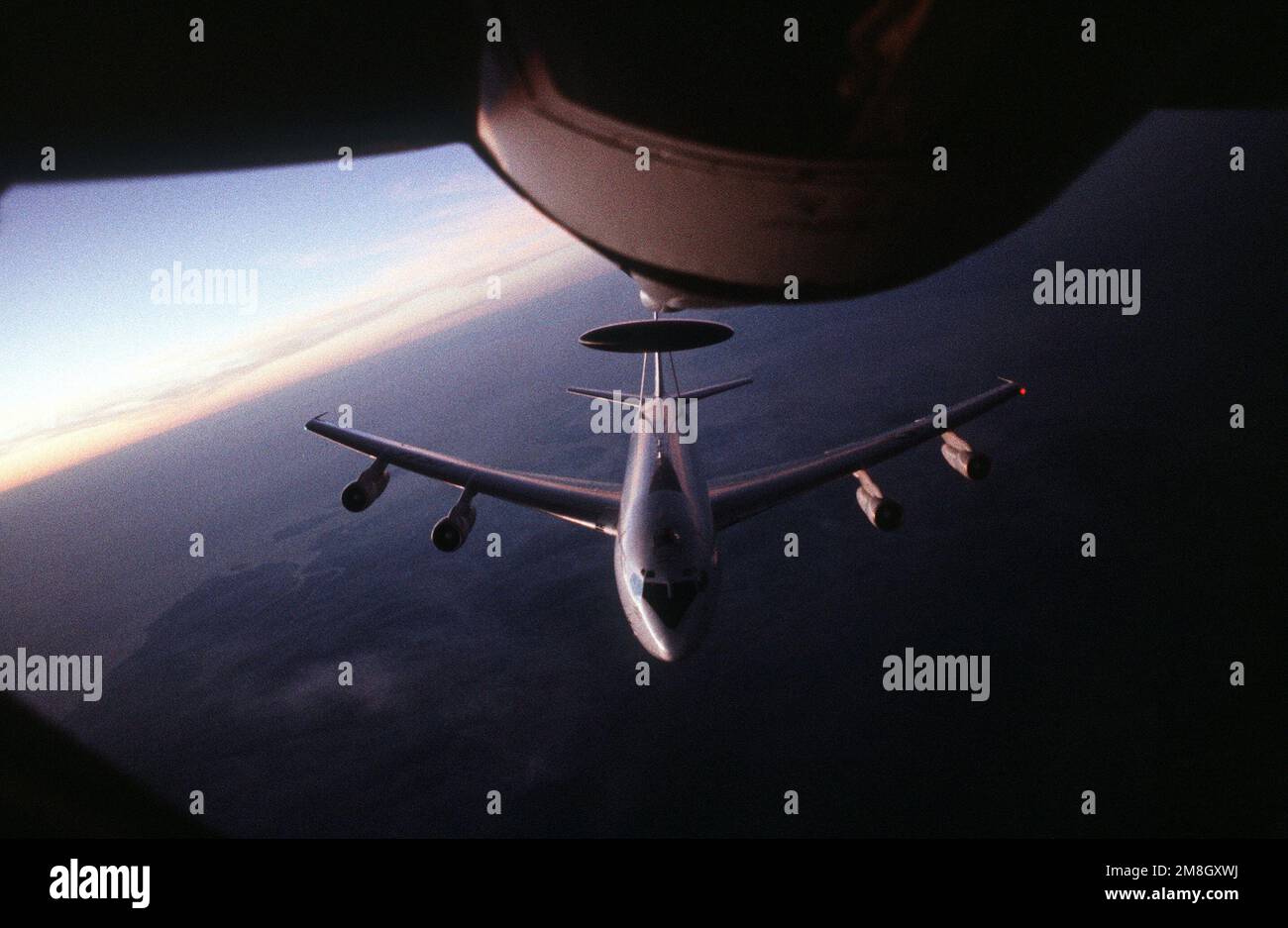 Aerial view at dusk as USAF E-3B Sentry (AWACS) aircraft moves into ...