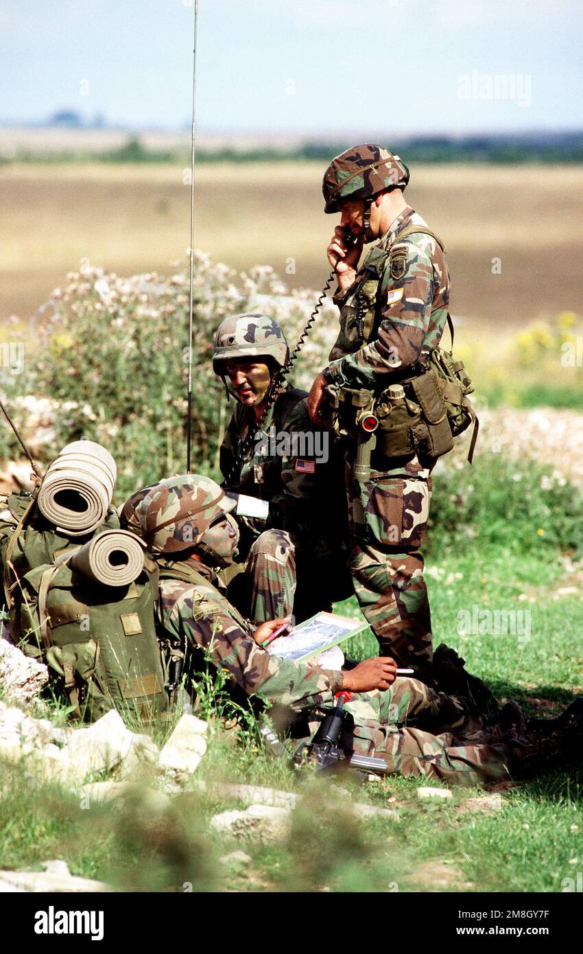 U.S. Army personnel direct activities with a field radio while trying ...