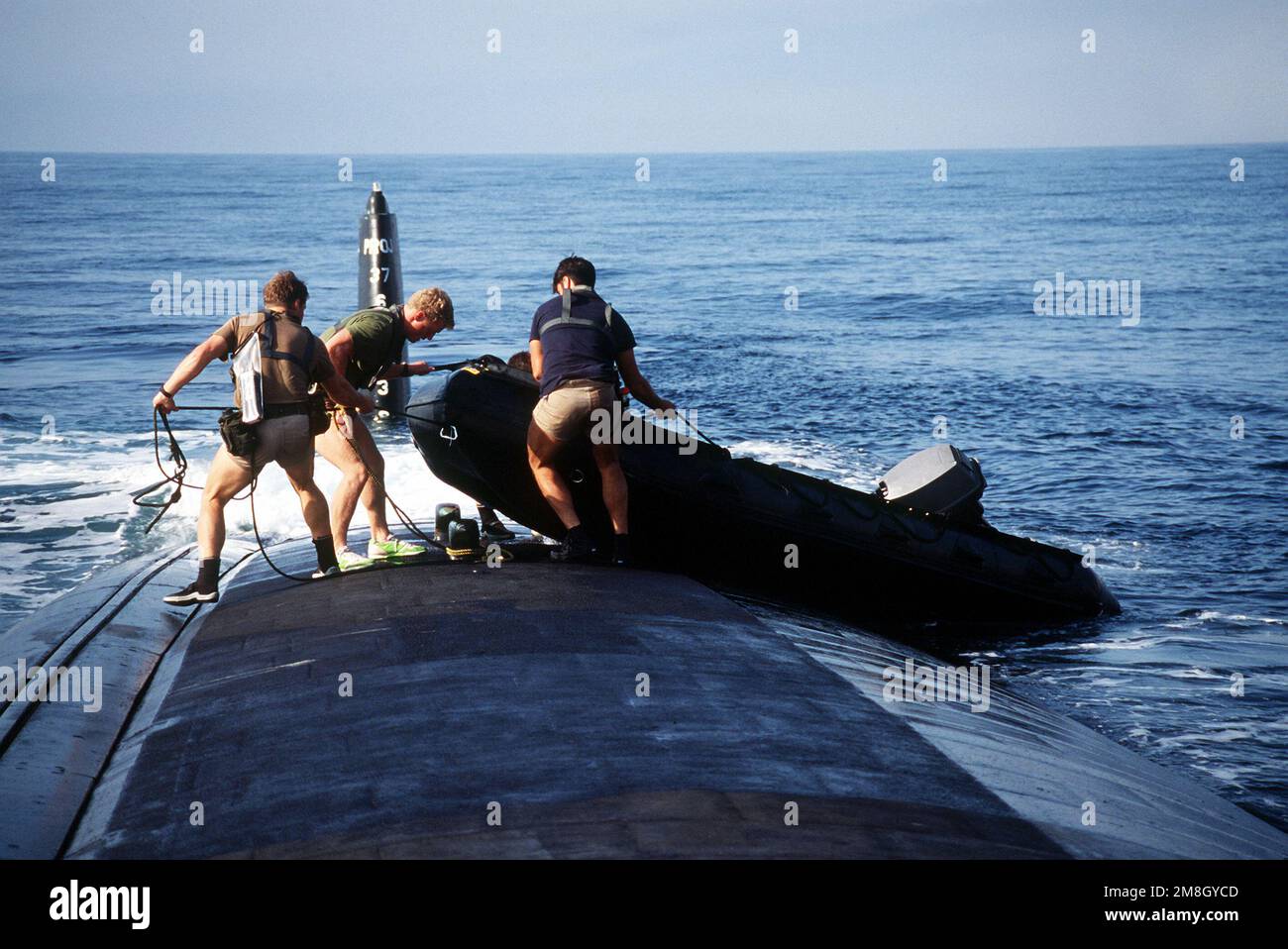 Several members of SEAL Team One are shown recovering a Zodiac boat on ...