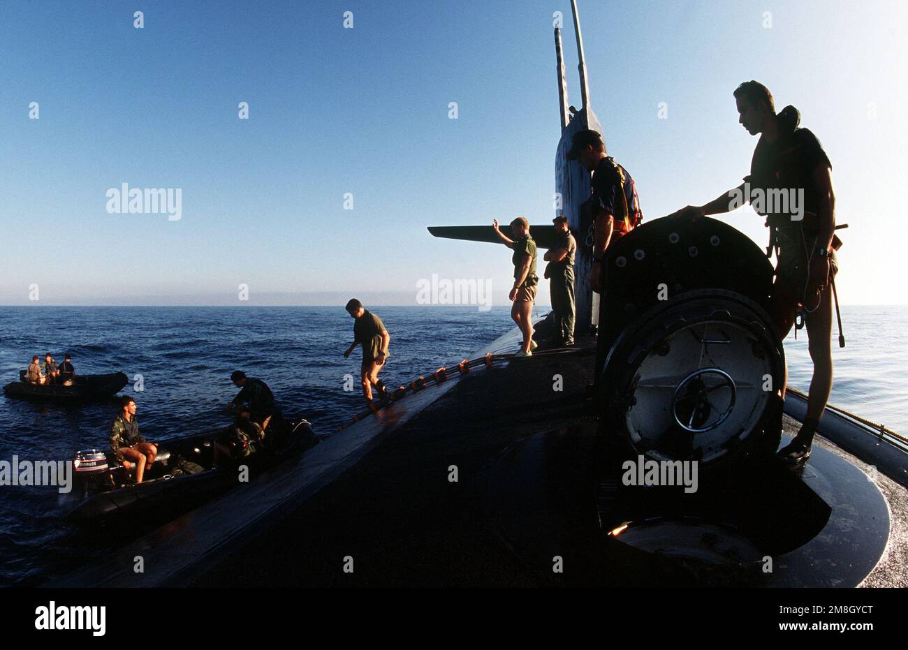 Members of SEAL Team One are shown coming alongside the nuclear-powered ...