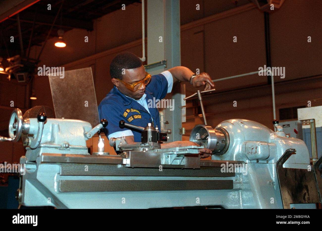 Machine Repairman Second Class (MR2) Sherrod is shown adjusting the ...