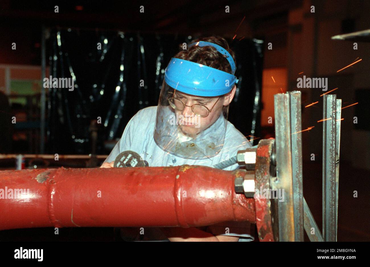 Hull Technician Fireman Apprentice (HTFA) Kita grinds out on a weld on ...