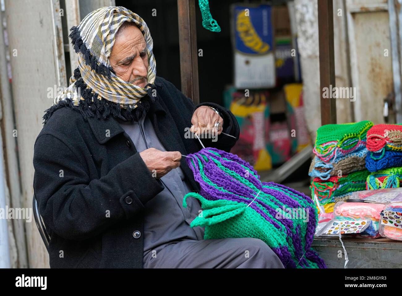 A street vendor waits for customers in the main Shurja market in ...