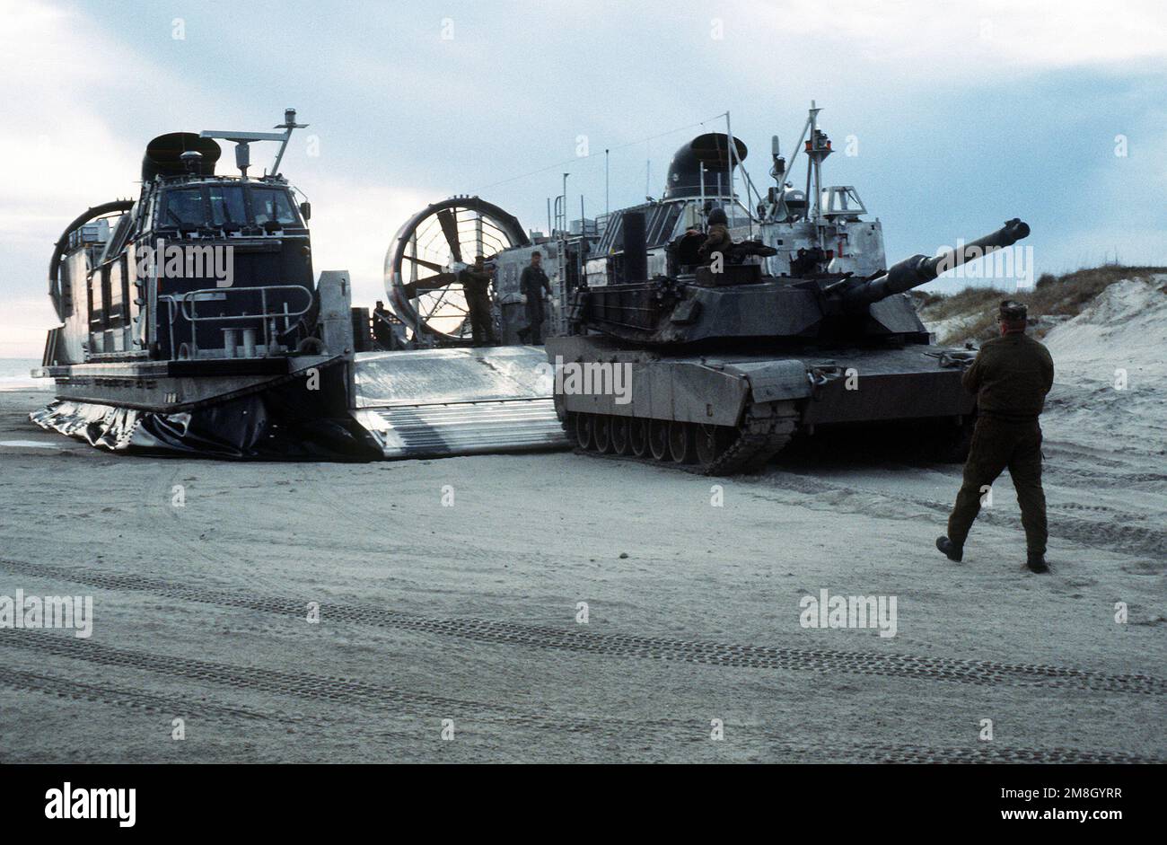 A Marine M1A1 Abrams Main Battle Tank is stopped at the loading ramp of ...