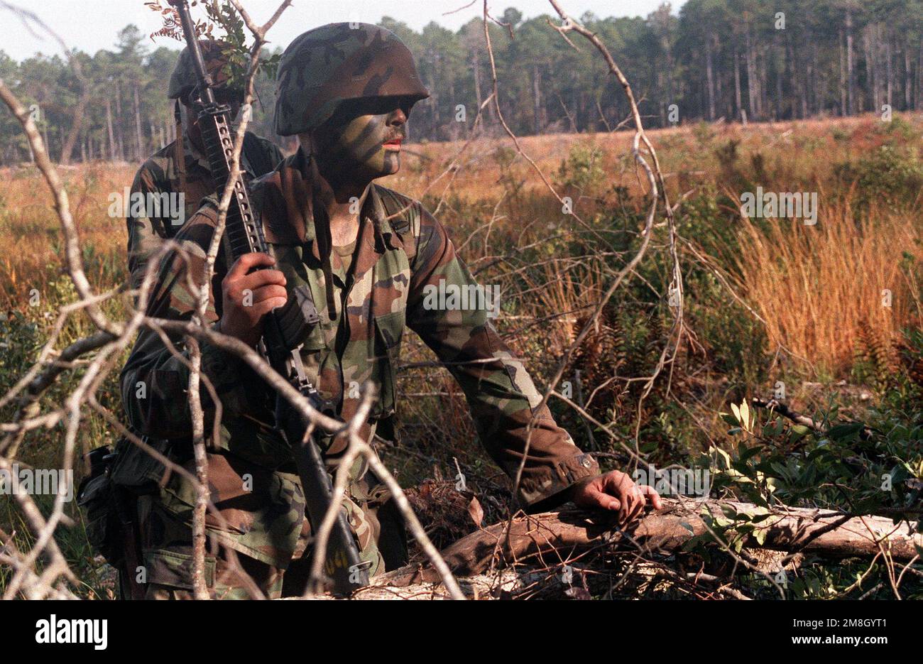 Two Marines with an M16A2 rifle, equipped with a blank firing adapter ...