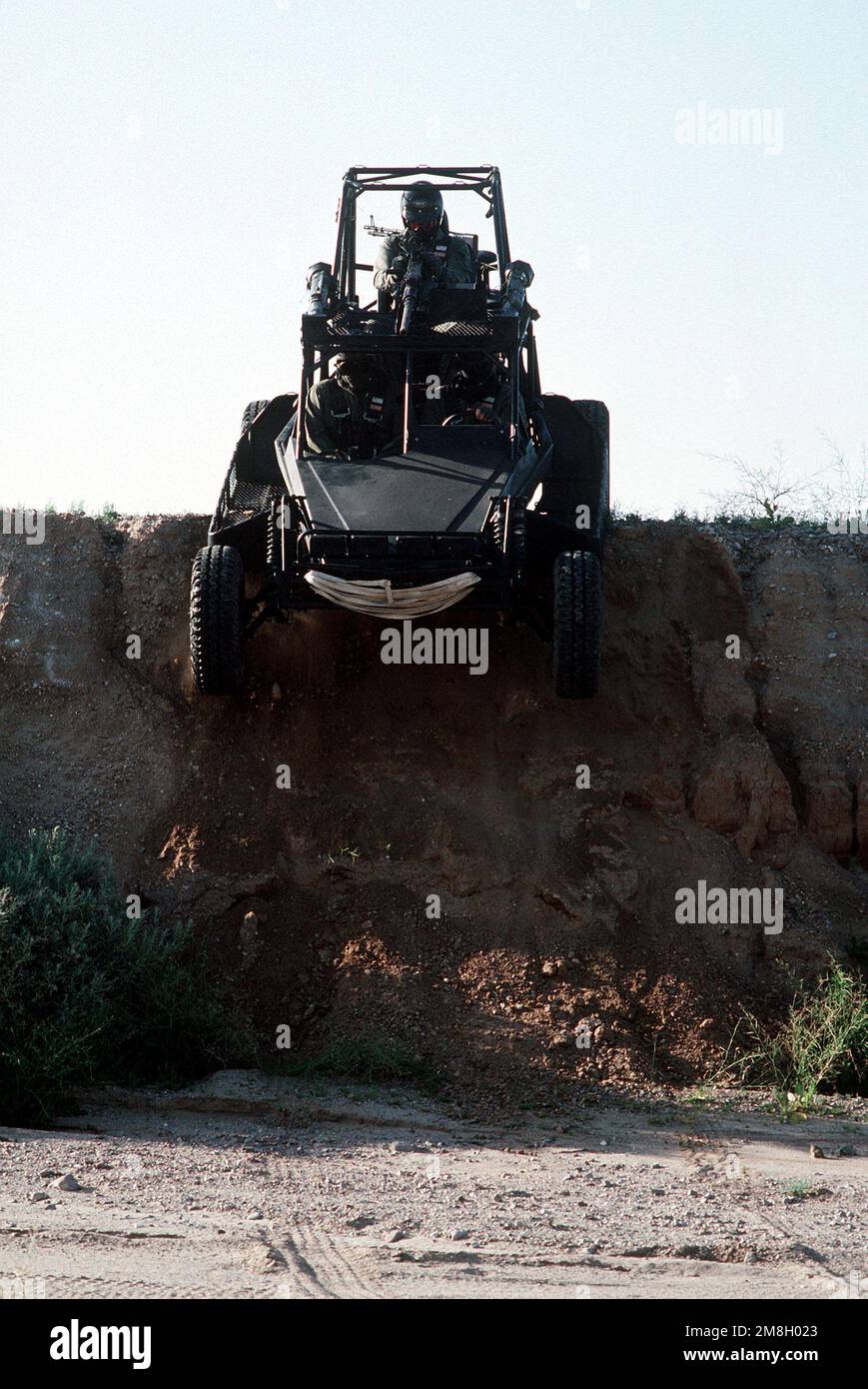 Members of Navy Sea-Air-Land (SEAL) Team 5 prepare to go over a ridge ...