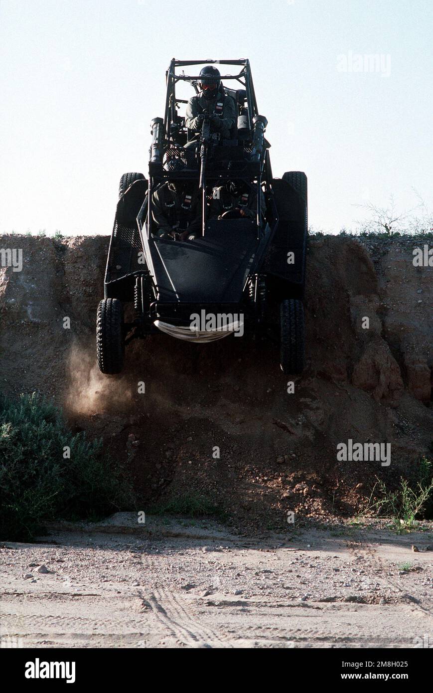 Members of Navy Sea-Air-Land (SEAL) Team 5 prepare to go over a ridge ...