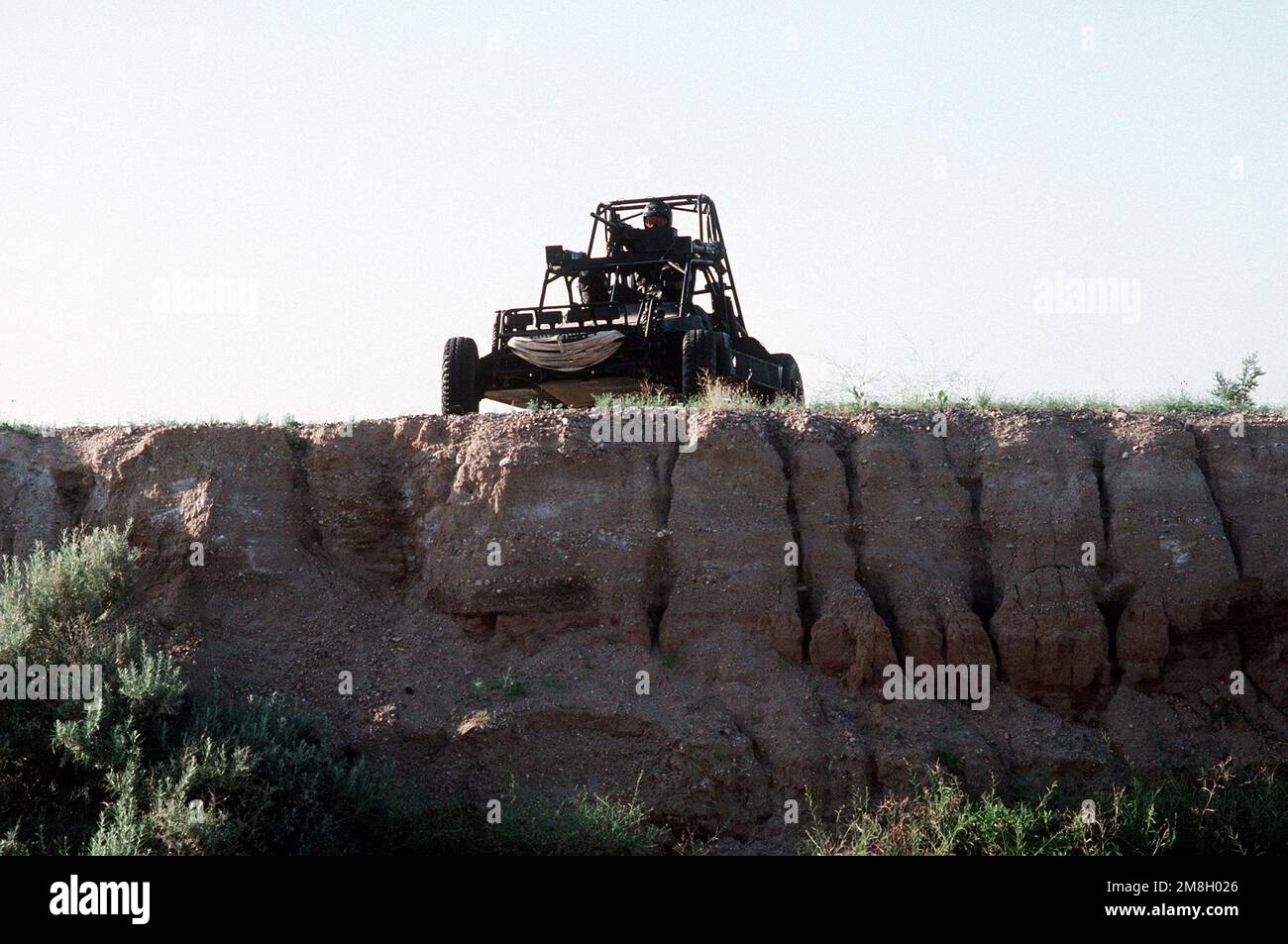 Members of Navy Sea-Air-Land (SEAL) Team 5 prepare to go over a ridge ...