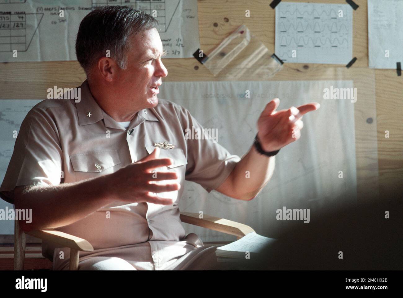 RADM James Perkins conducts a briefing during the multinational relief ...