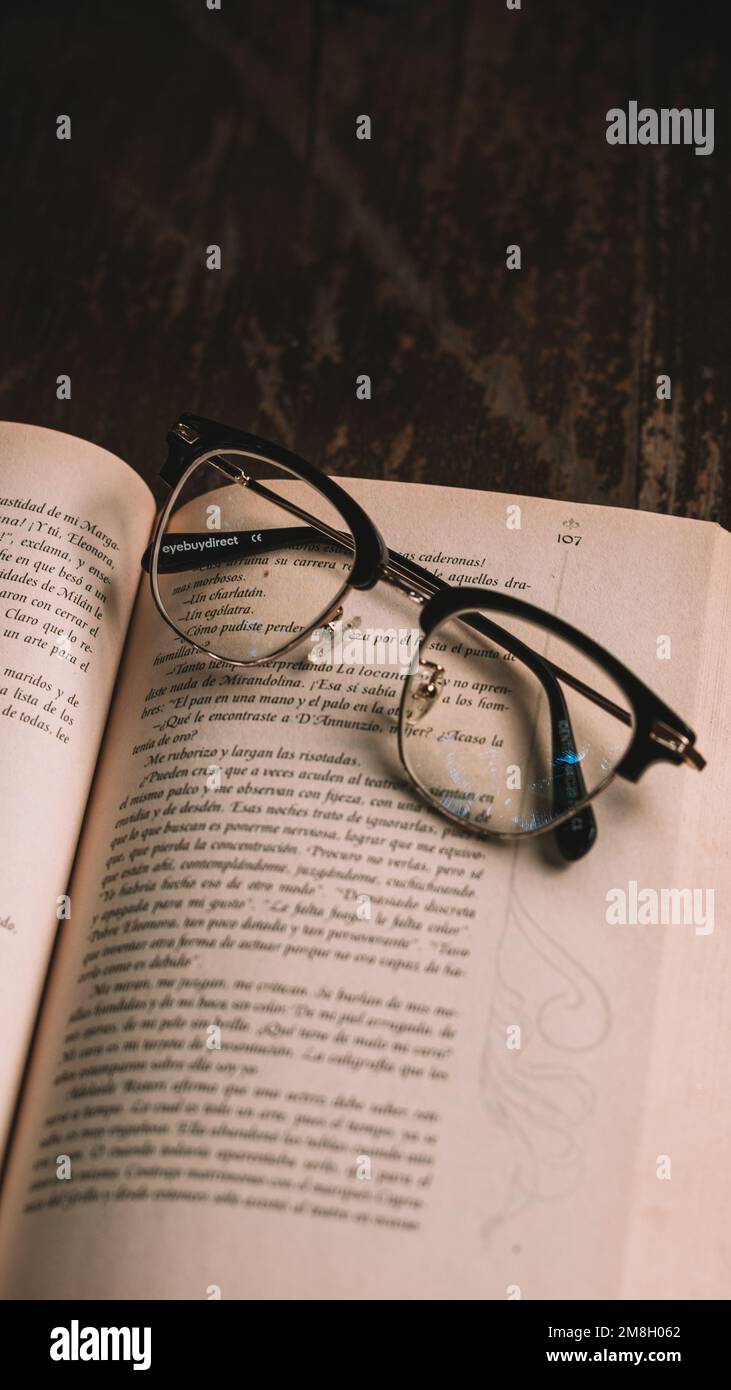 A closeup of glasses on open book Stock Photo - Alamy