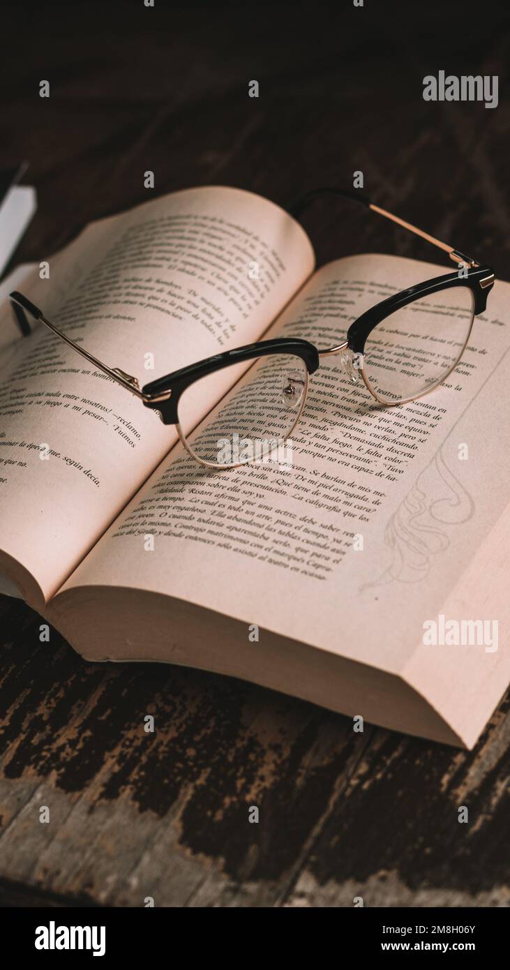 A closeup of glasses on open book Stock Photo - Alamy