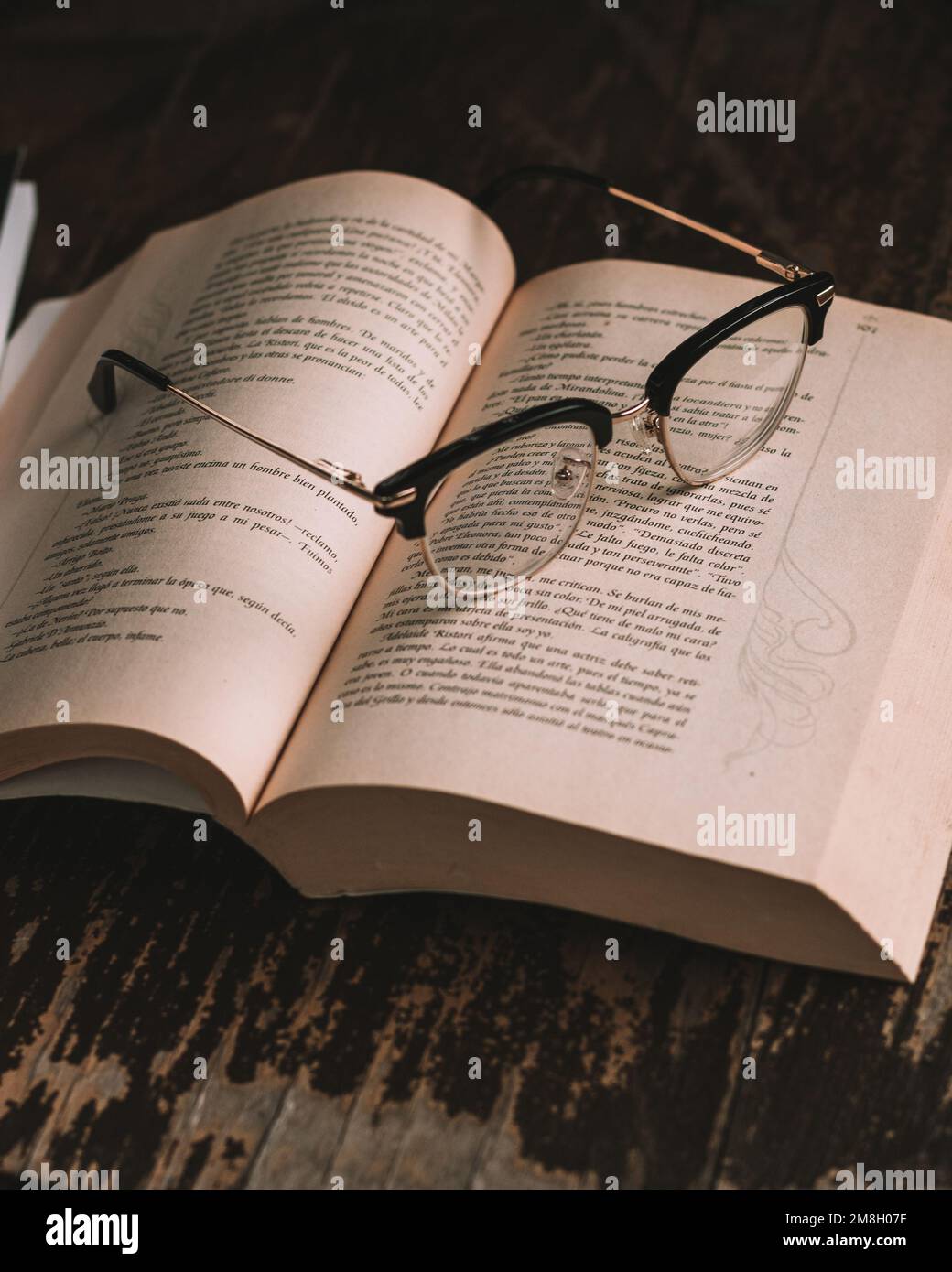A closeup of glasses on open book Stock Photo - Alamy