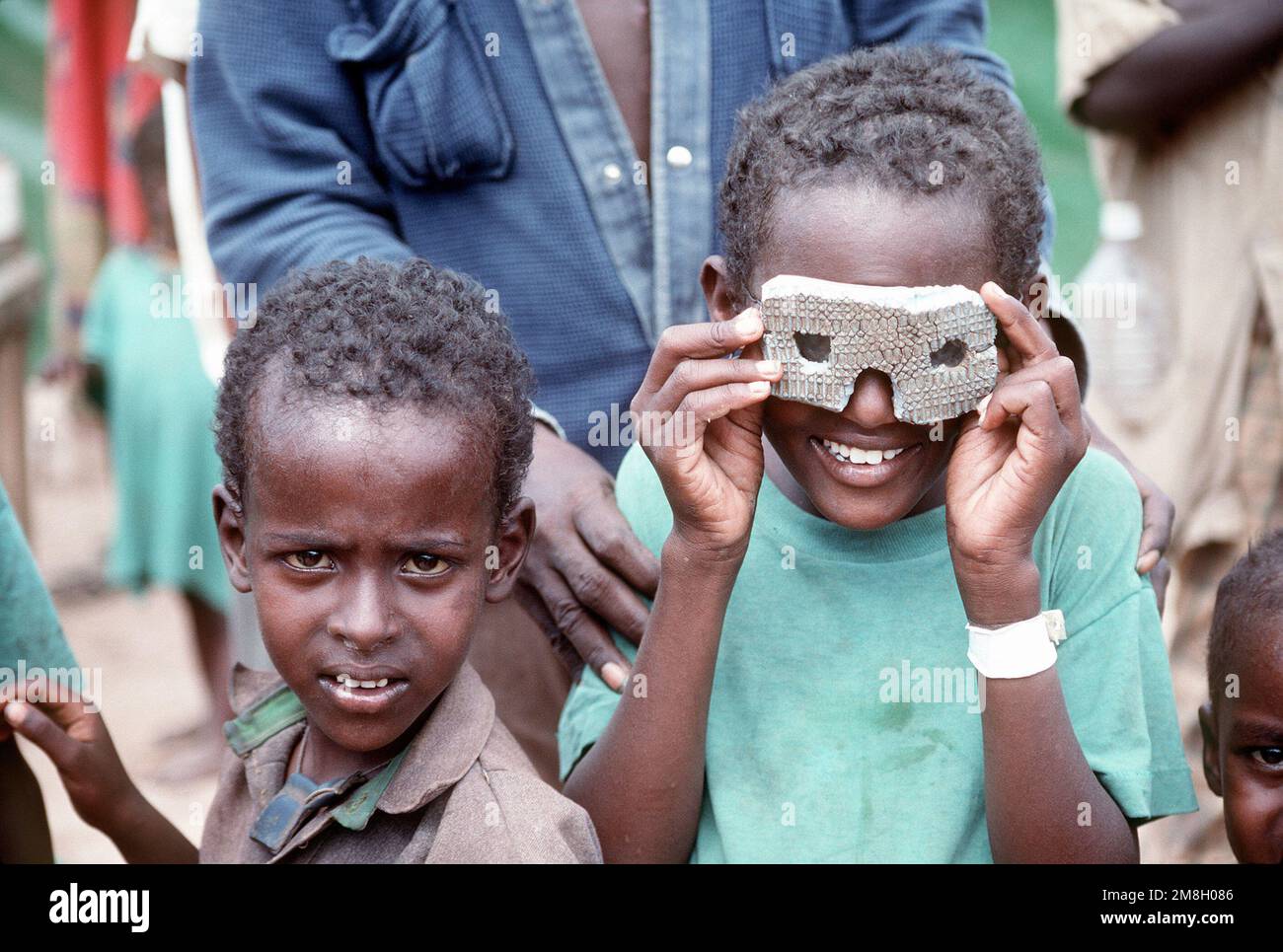 A Somali boy wears a pair of glasses while standing in line at the ...