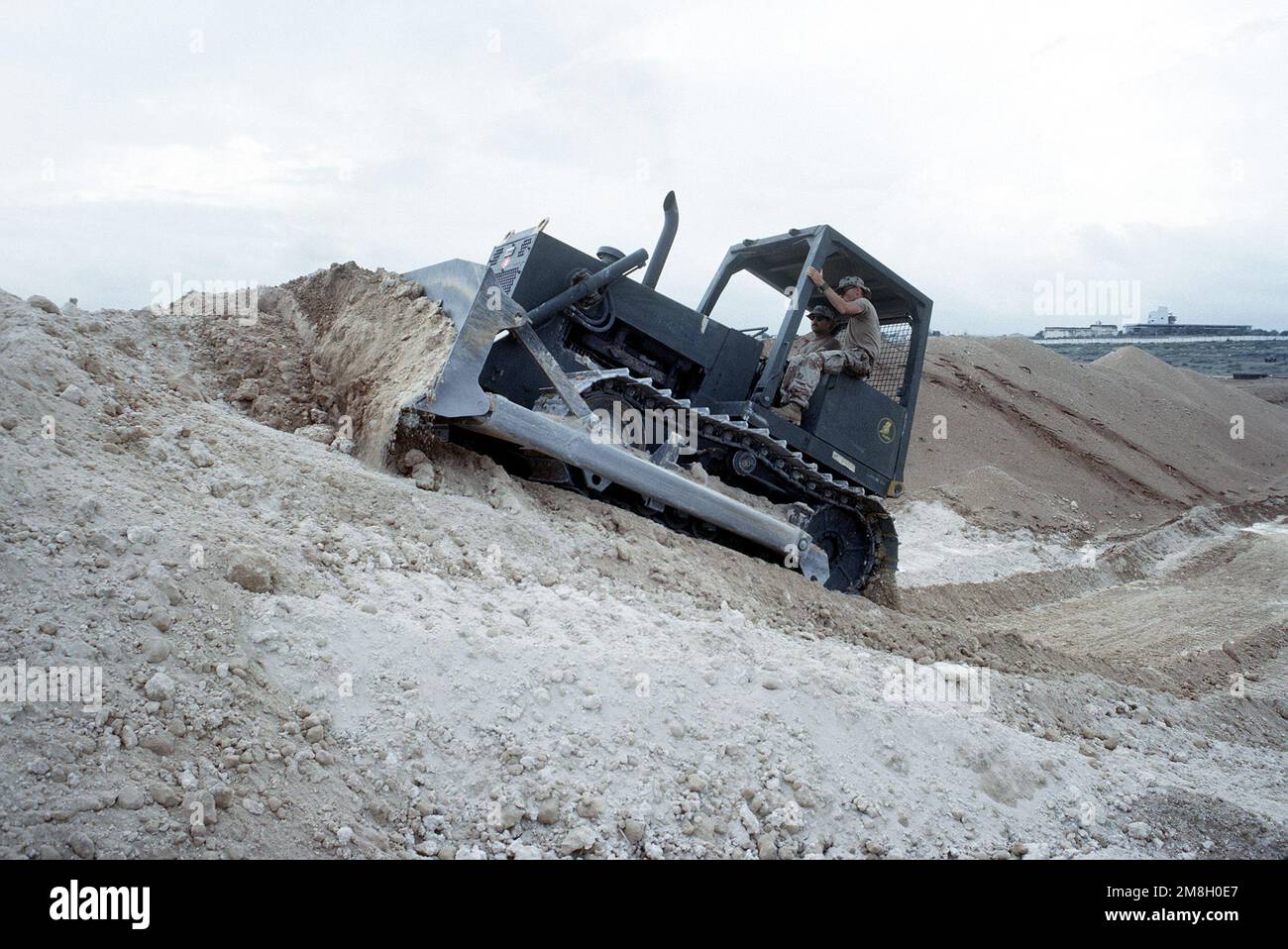Members of Naval Mobile Construction Battalion 40 (NMCB-40) use a ...
