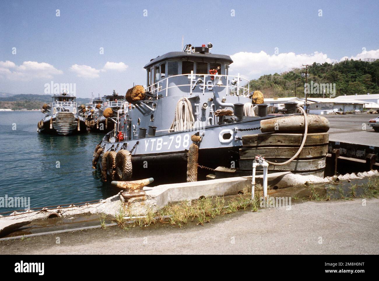 A starboard bow view of the large harbor tug OPELIKA (YTB-798) moored ...