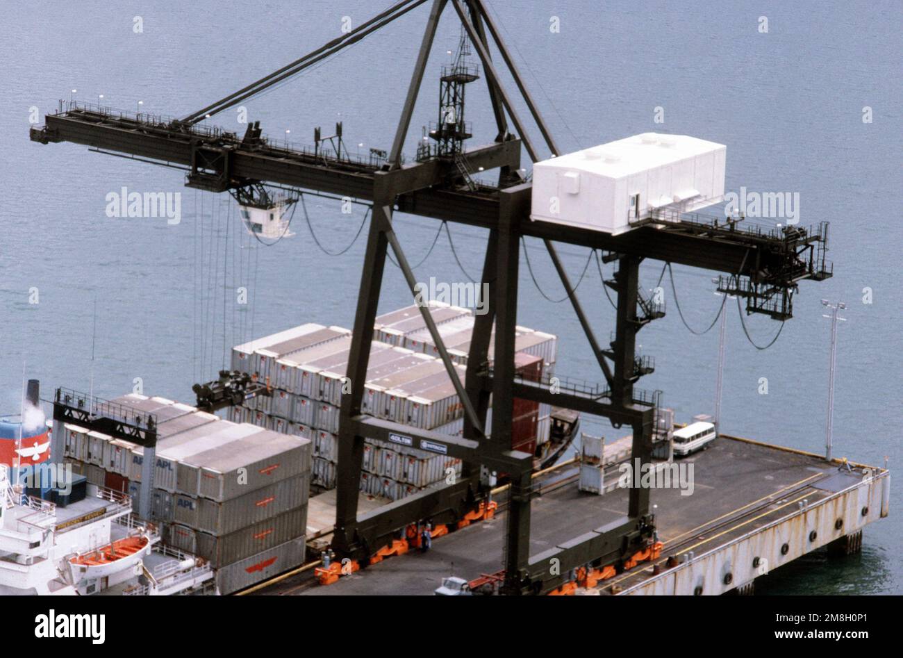 A crane removes cargo from the container ship PRESIDENT KENNEDY. The ...