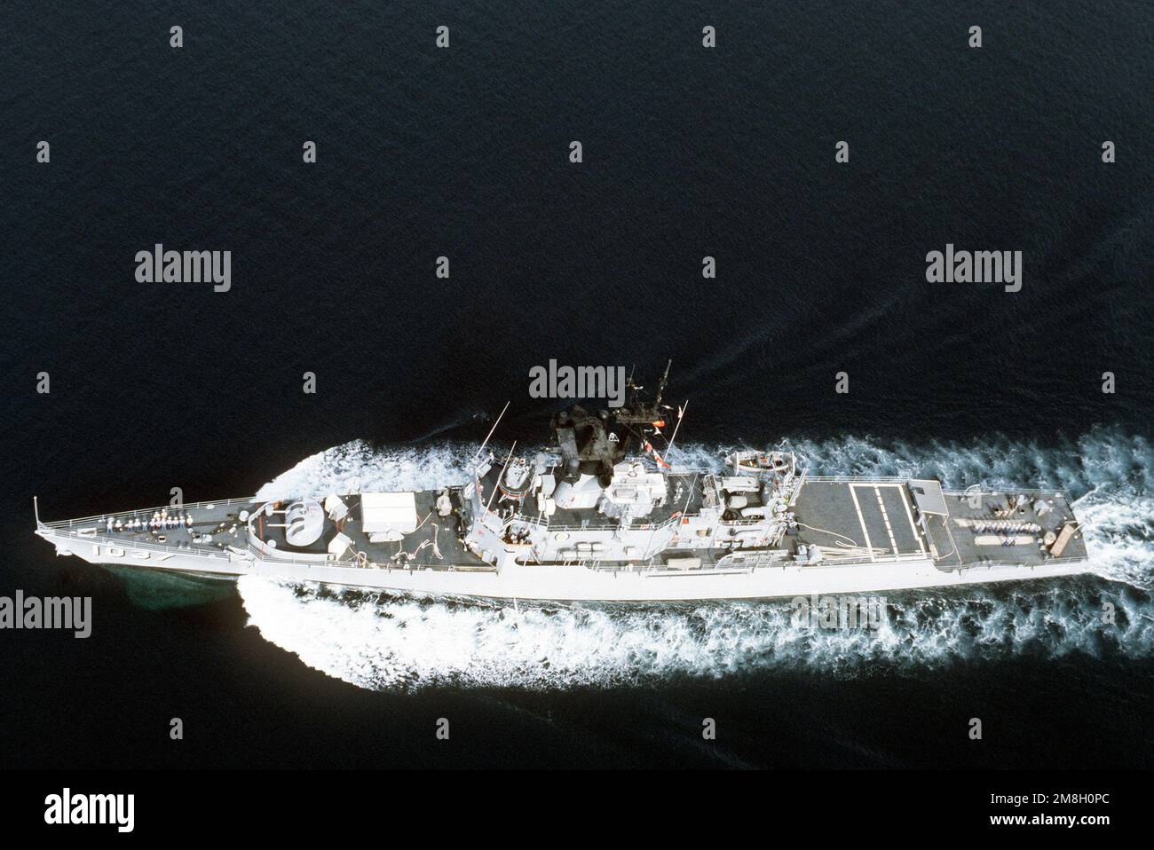 Members of the deck force stand in formation on the deck of the frigate ...