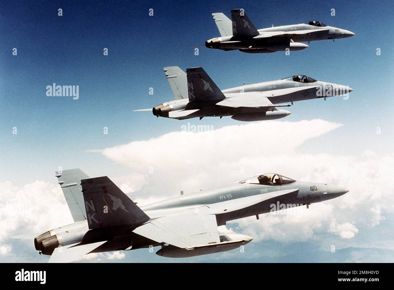 An air-to-air view of three Strike Fighter Squadron 25 (VFA-25) F/A-18A ...