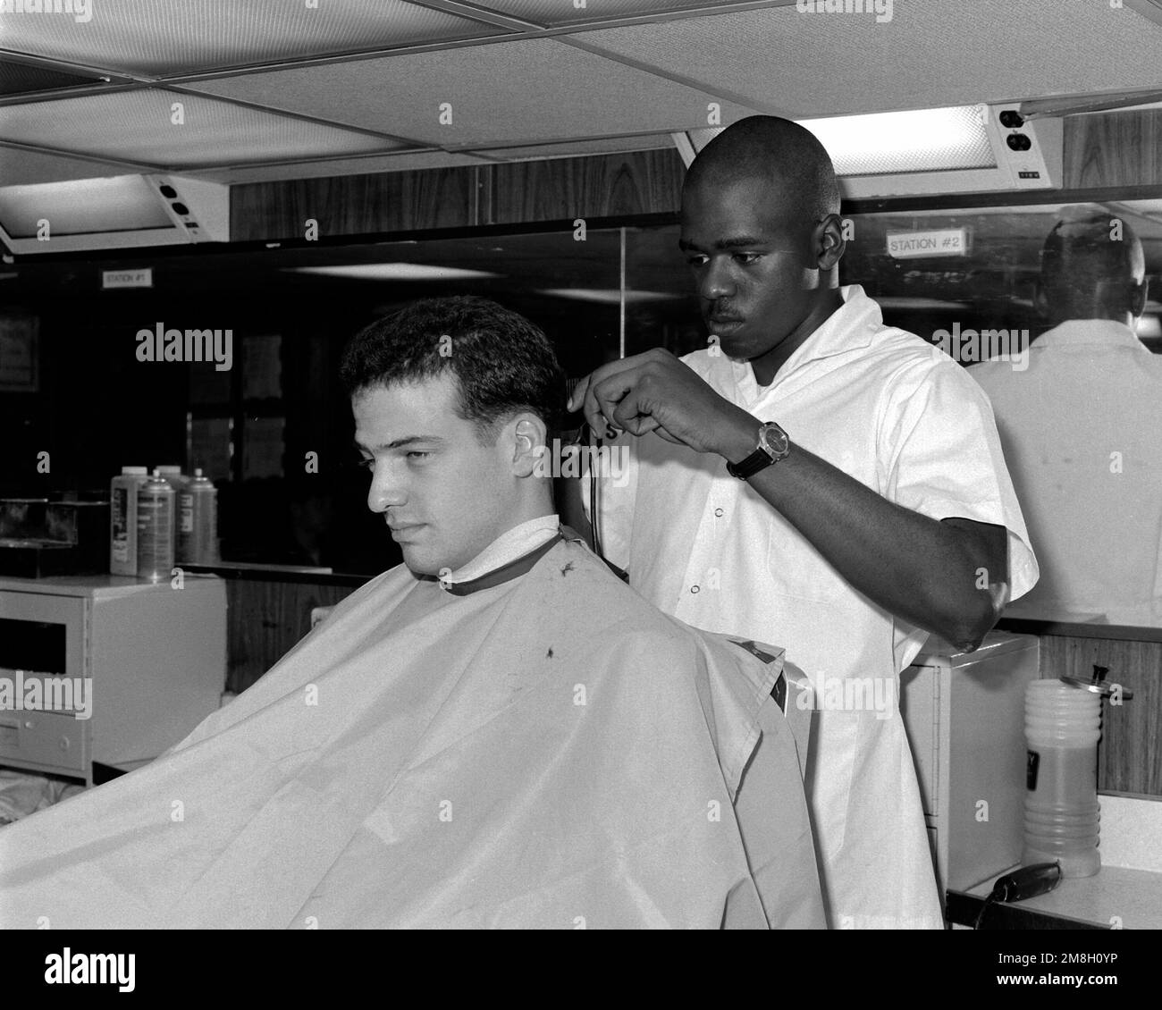 Ship's Serviceman SEAMAN M. Henderson of the S-3 Division gives a ...